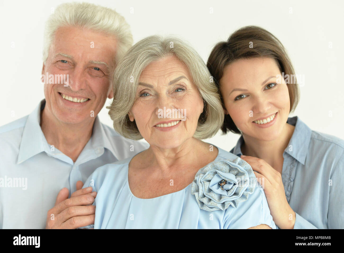 close up family portrait of happy parents with adult daughter posing ...