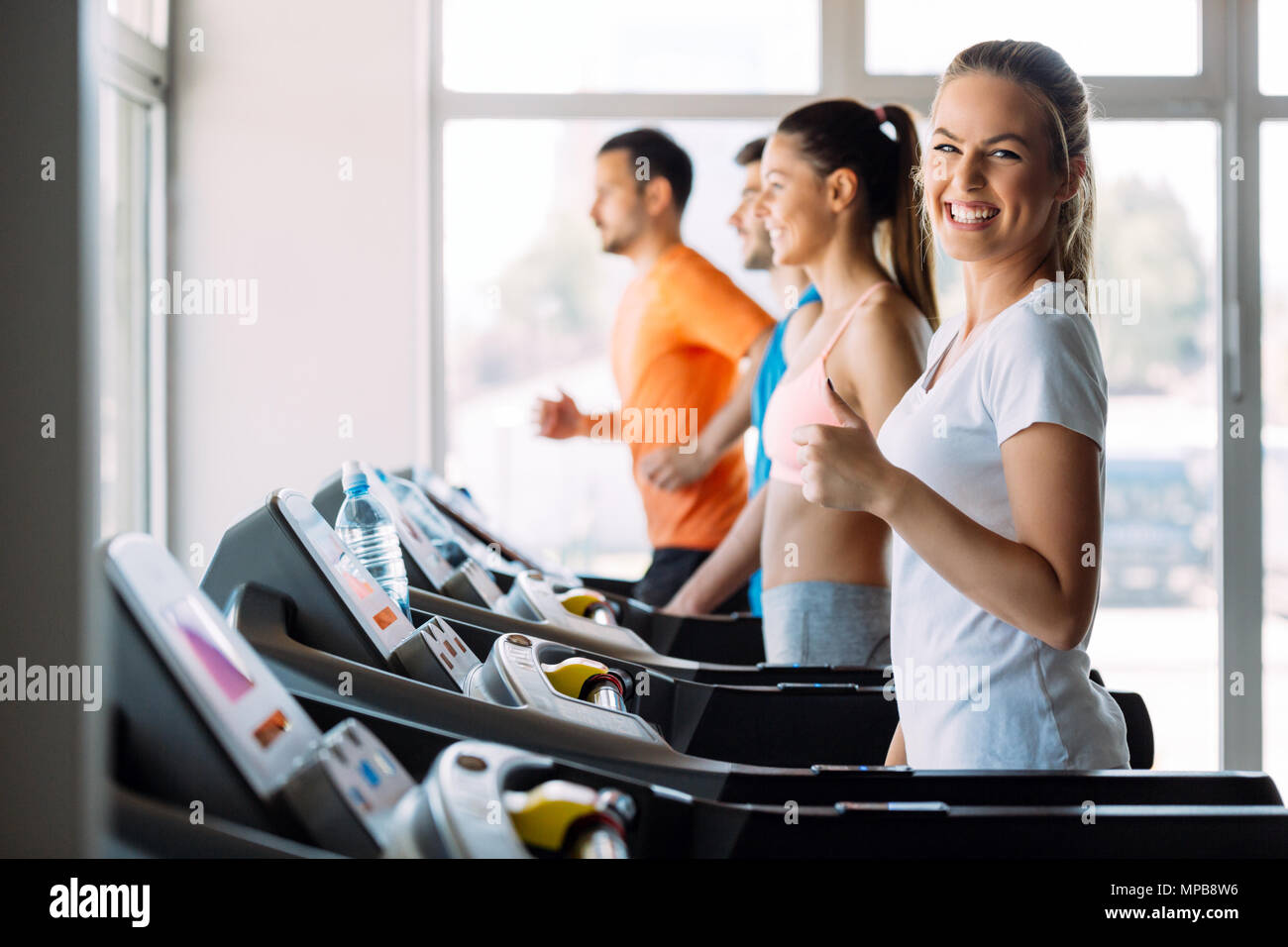 Picture of people running on treadmill in gym Stock Photo - Alamy