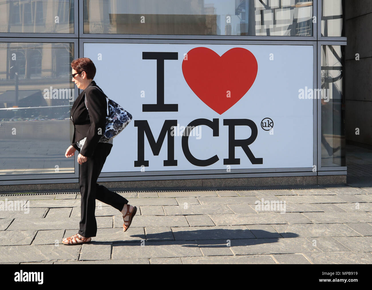 A woman walks past a 'I Love Manchester' sign ahead of the Manchester ...