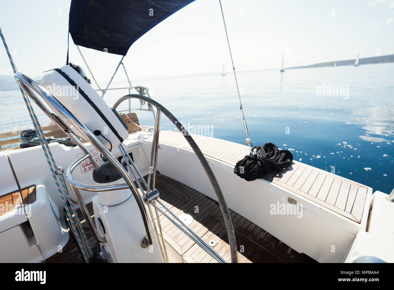 Modern ship control panel with steering wheel Stock Photo - Alamy