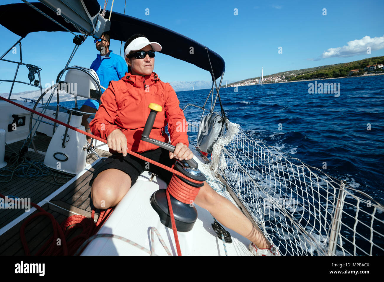 Attractive strong woman sailing with her boat Stock Photo - Alamy