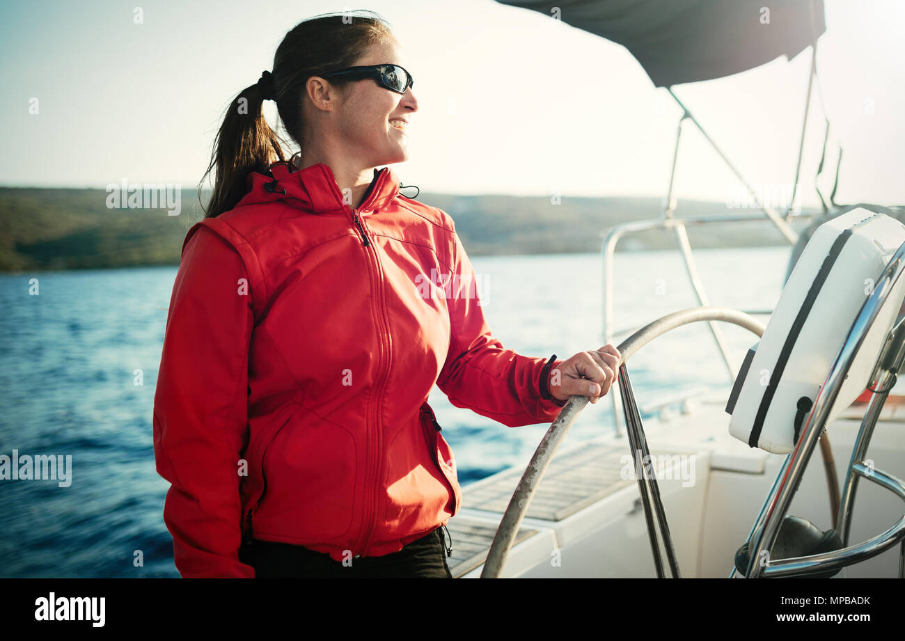 Attractive strong woman sailing with her boat Stock Photo - Alamy
