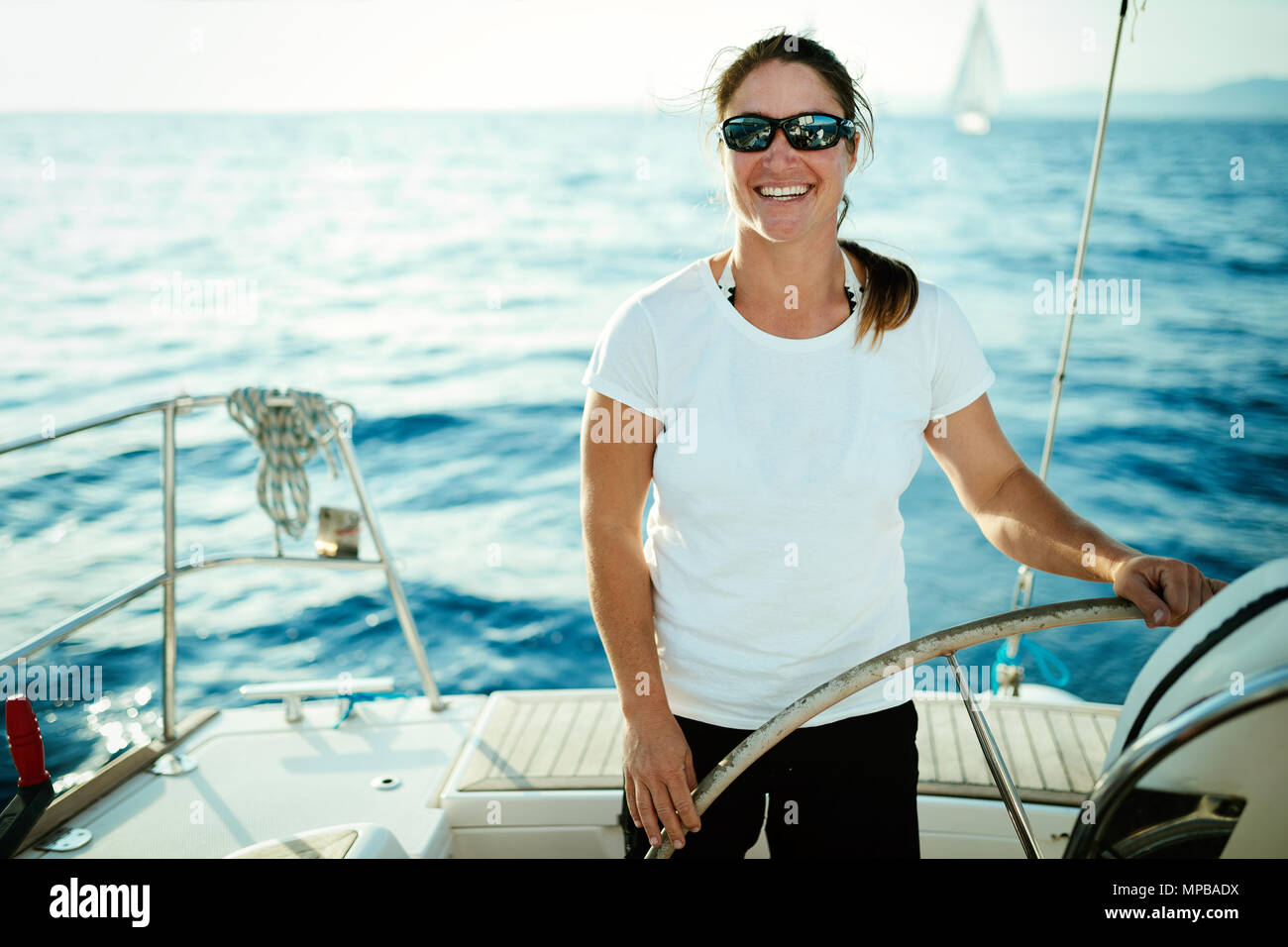 Attractive strong woman sailing with her boat Stock Photo - Alamy
