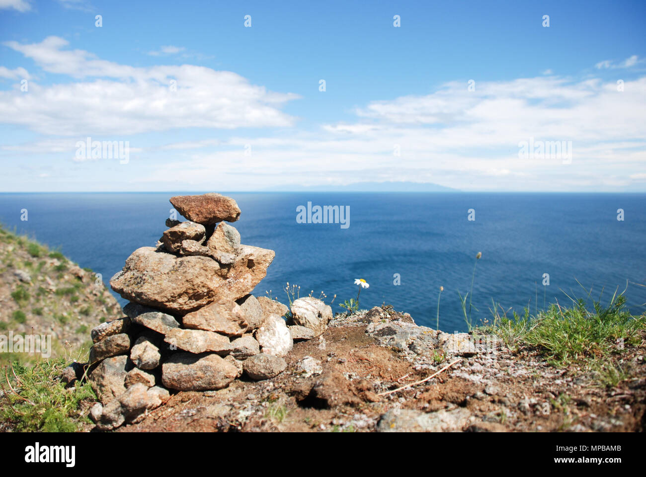 Stacked balance cairn with sea background Stock Photo - Alamy
