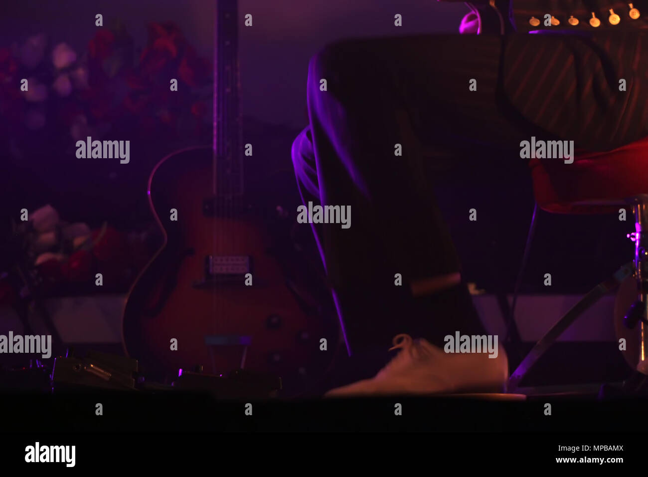 Musician feet and guitar on stage Stock Photo - Alamy