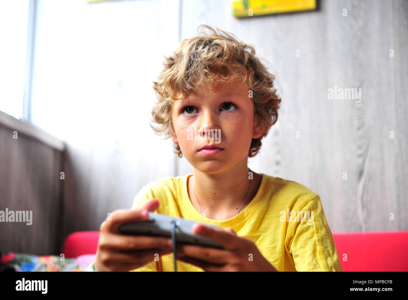Boy playing computer game joystick hi-res stock photography and images ...