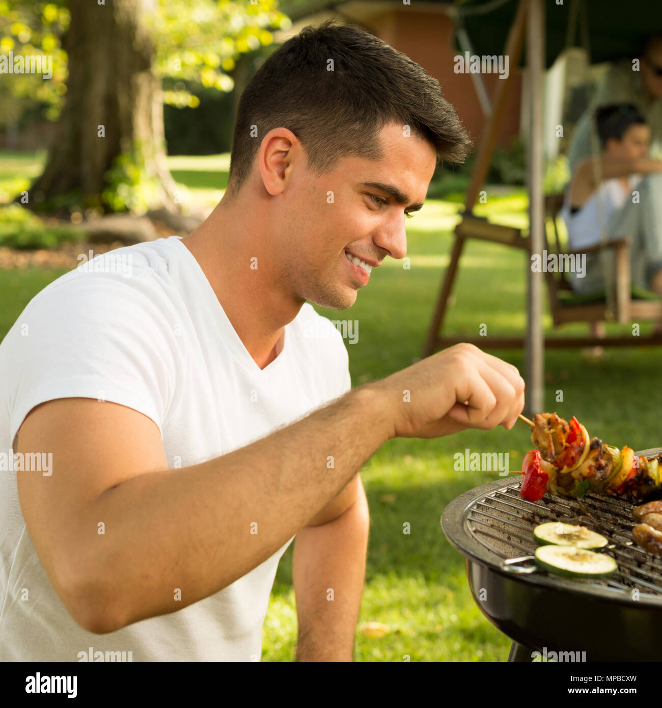 Man making barbeque meat food hi-res stock photography and images - Alamy