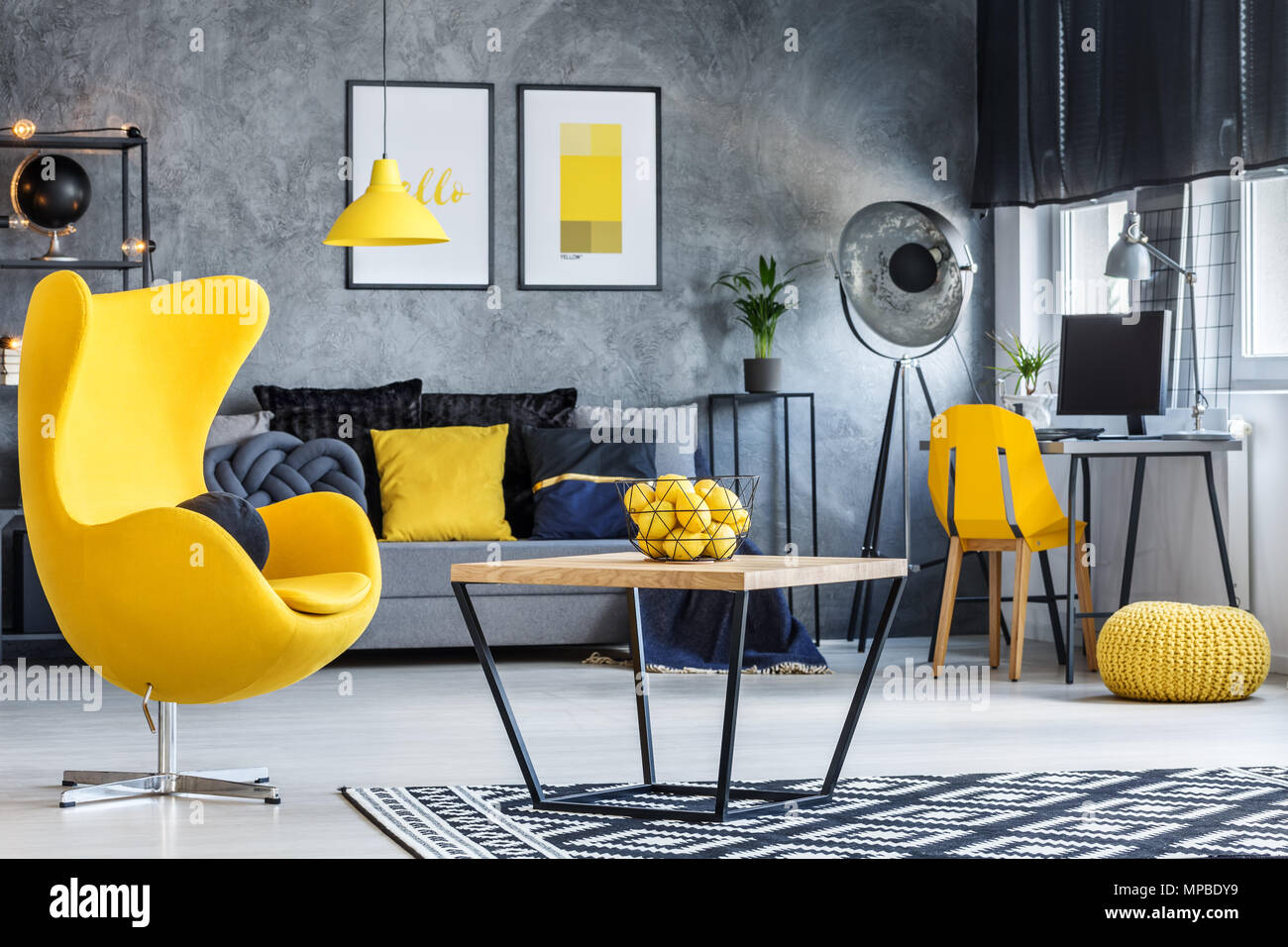 Hipster room with coffee table, yellow designer armchair and concrete ...