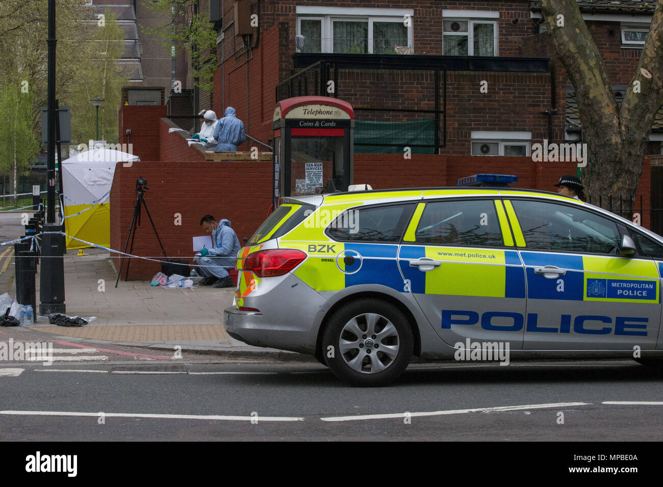 Police officers search crime scene of fatal stabbing at Roth Walk ...