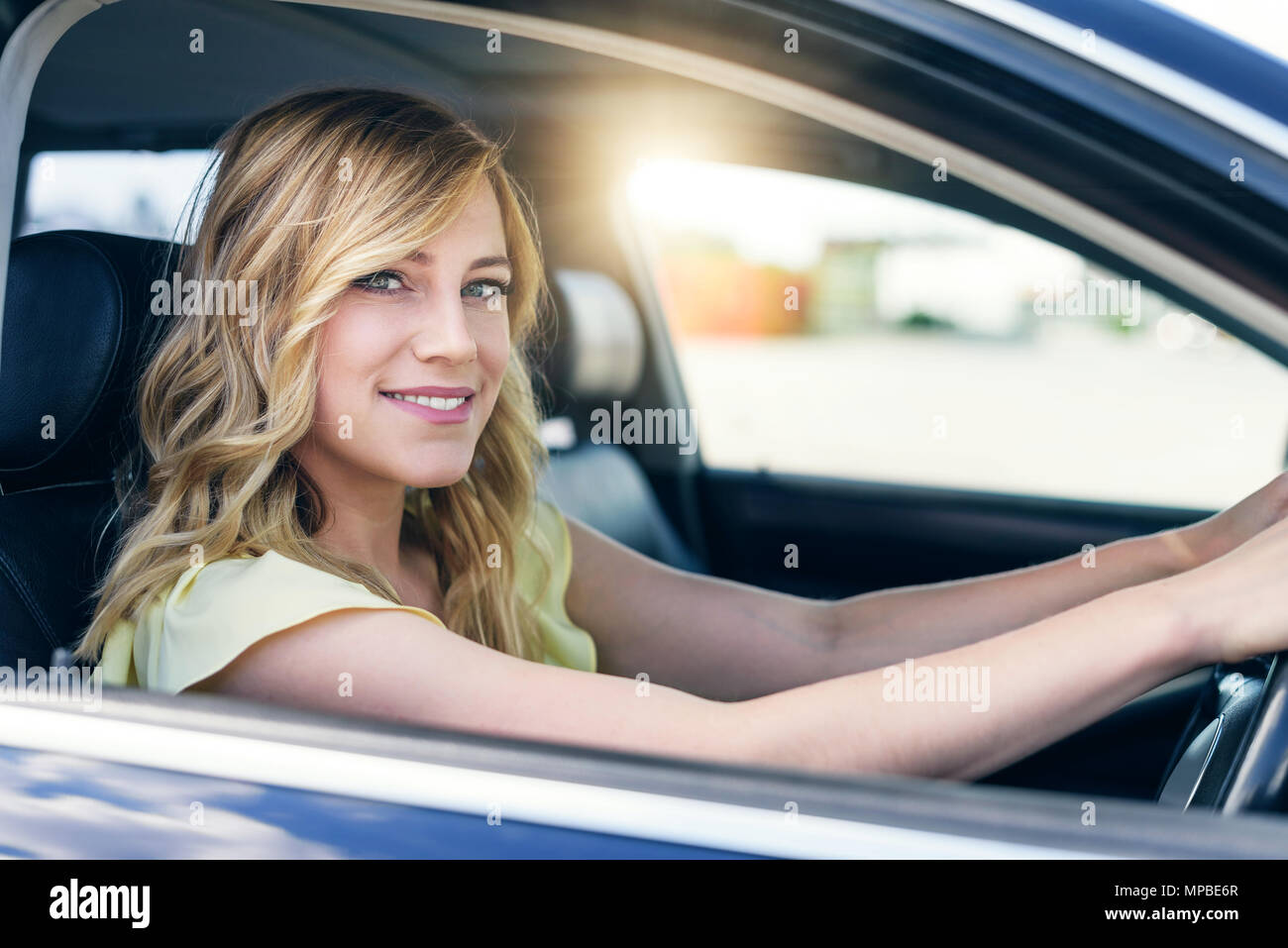 Attractive young woman driving a car Stock Photo - Alamy