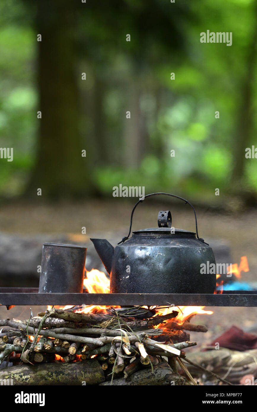 Blackened kettle on an open campfire Stock Photo - Alamy