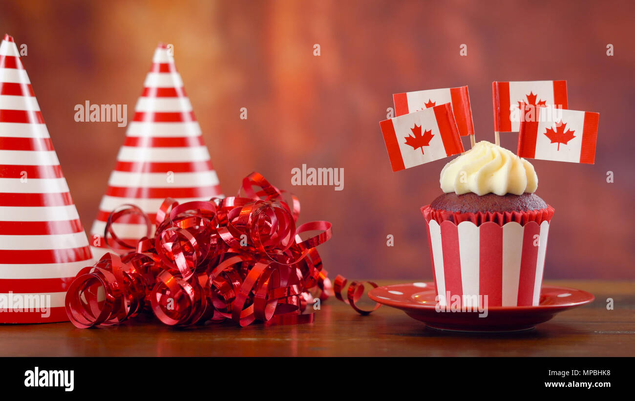 Red and white theme cupcakes with Canadian maple leaf flags for first ...