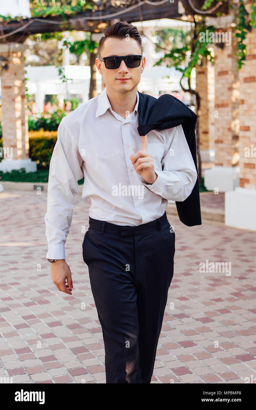 Young businessman walking outdoors in a tropical country Stock Photo ...