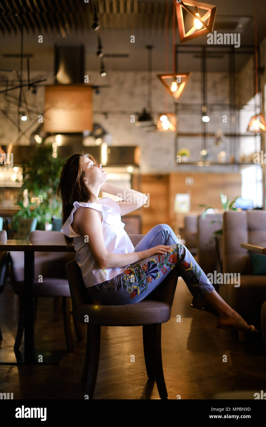 Person sitting on chair jeans back hi-res stock photography and images ...