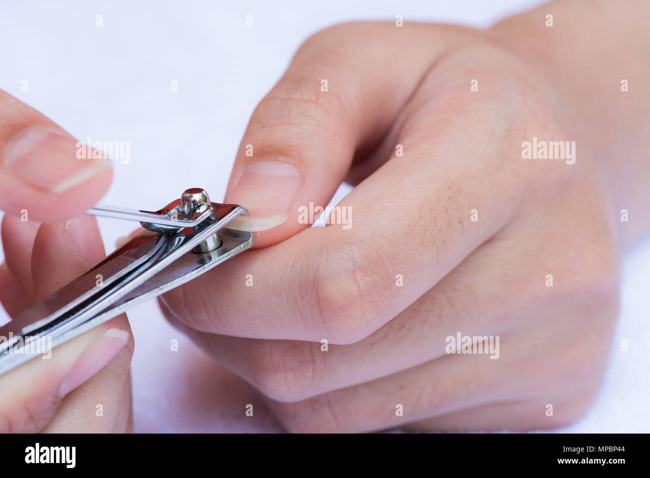 Closeup of a woman cutting nails, health care concept Stock Photo - Alamy