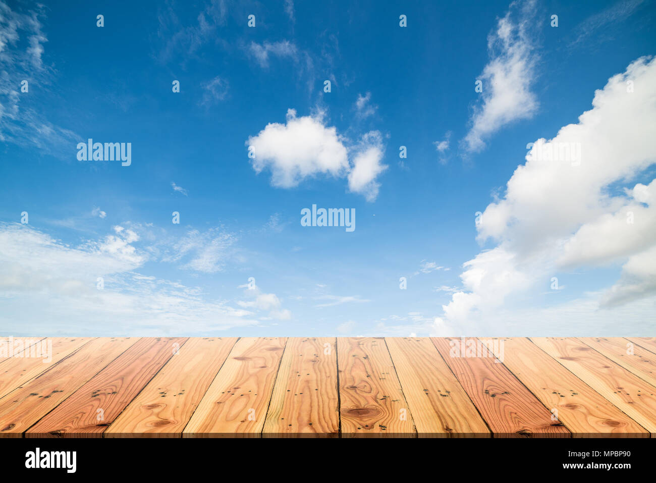 Wooden table on blue sky and white cloud background for spring or ...