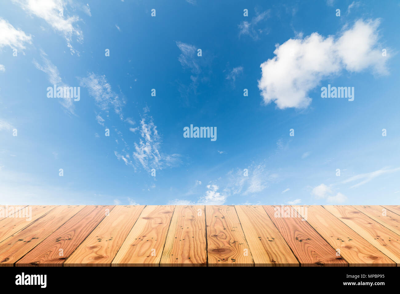 Wooden table on blue sky and white cloud background for spring or ...