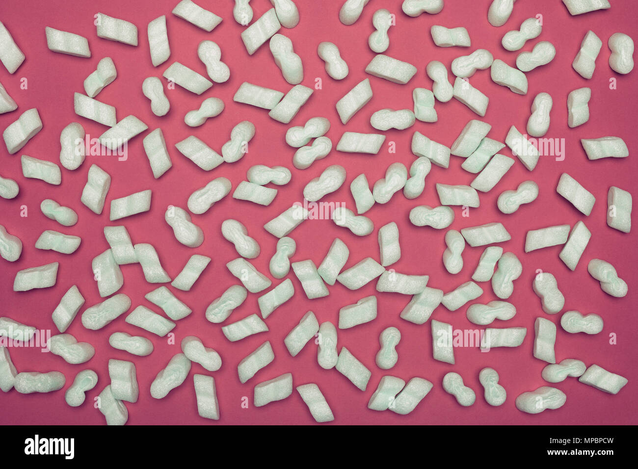Full frame shot of packing peanuts on pink background Stock Photo - Alamy