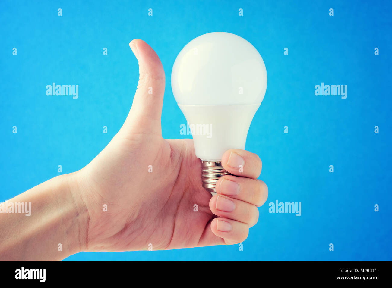 the woman is holding a light bulb in her hands and showing the likes ...