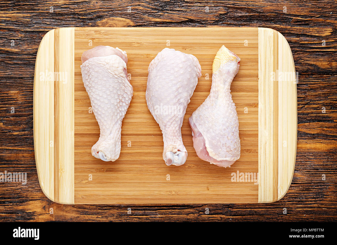 Raw chicken legs on a wooden board, top view, horizontal photo Stock ...