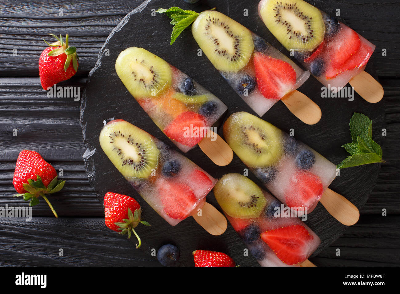 Homemade fruit ice from fresh strawberries, kiwi and blueberries with ...