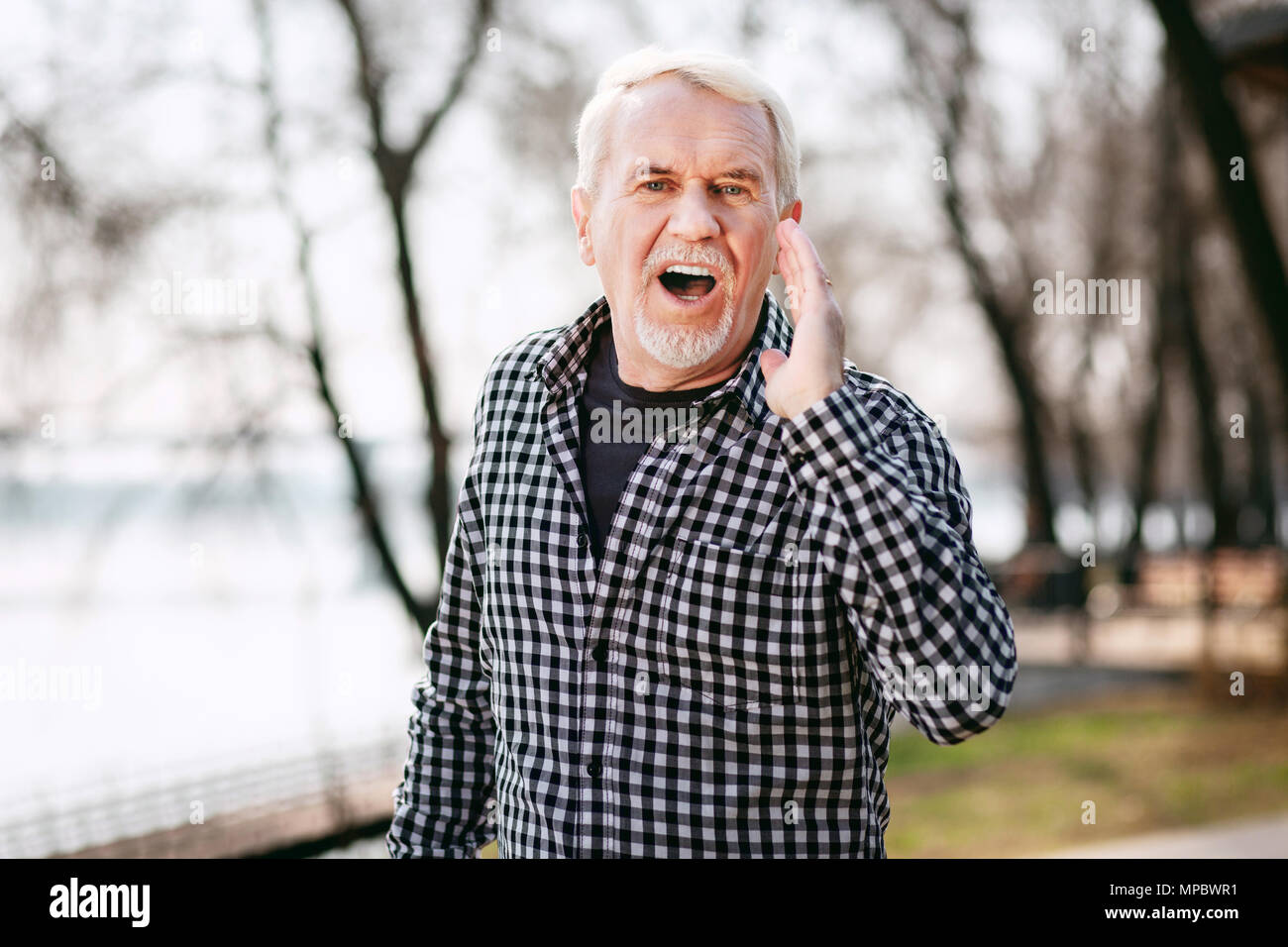 Energetic senior man calling Stock Photo - Alamy