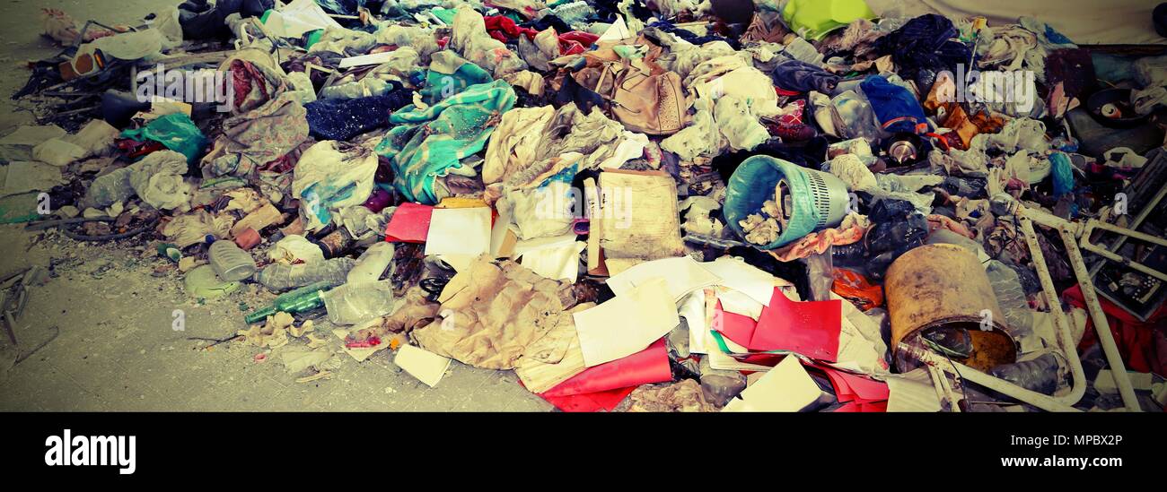 unauthorized junkyard with many dirty objects symbol of the human ...