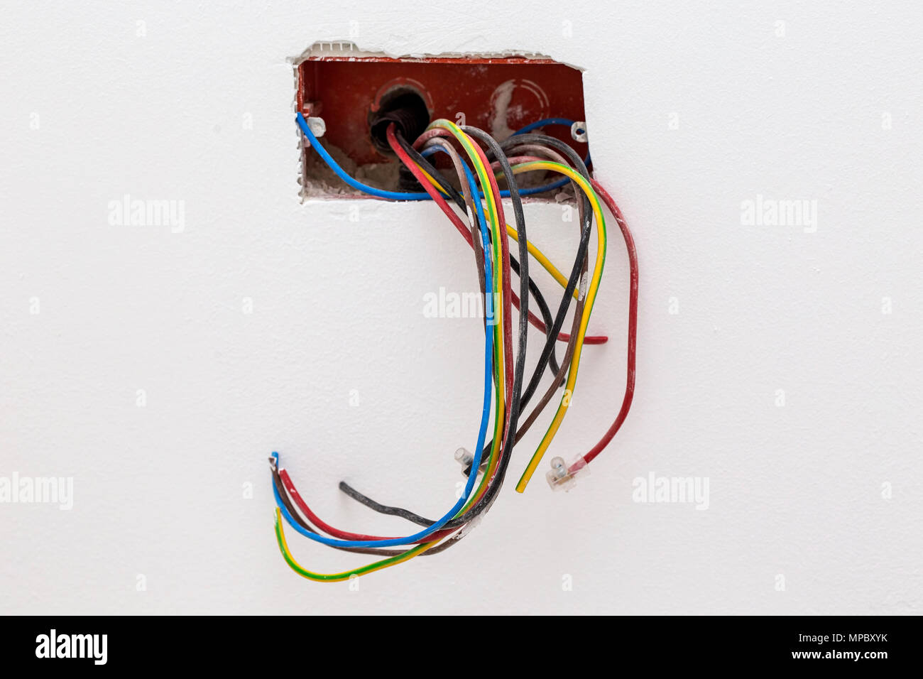 Unfinished electrical mains outlet socket with electrical wires ...