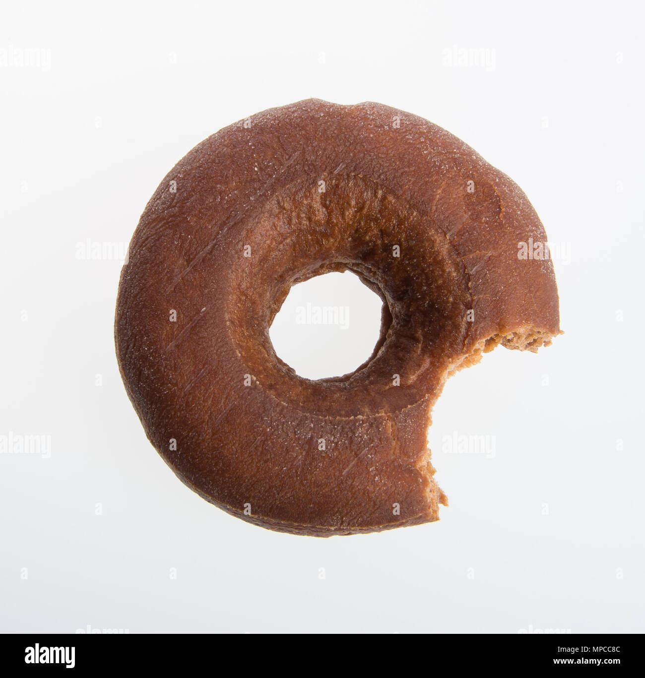 donut or donut with missing bite on a background Stock Photo - Alamy