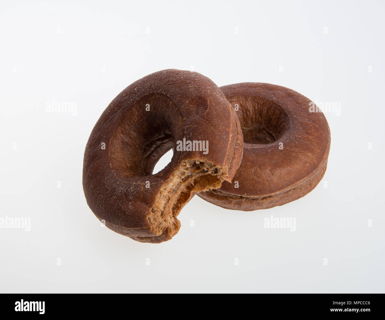 donut or donut with missing bite on a background Stock Photo - Alamy