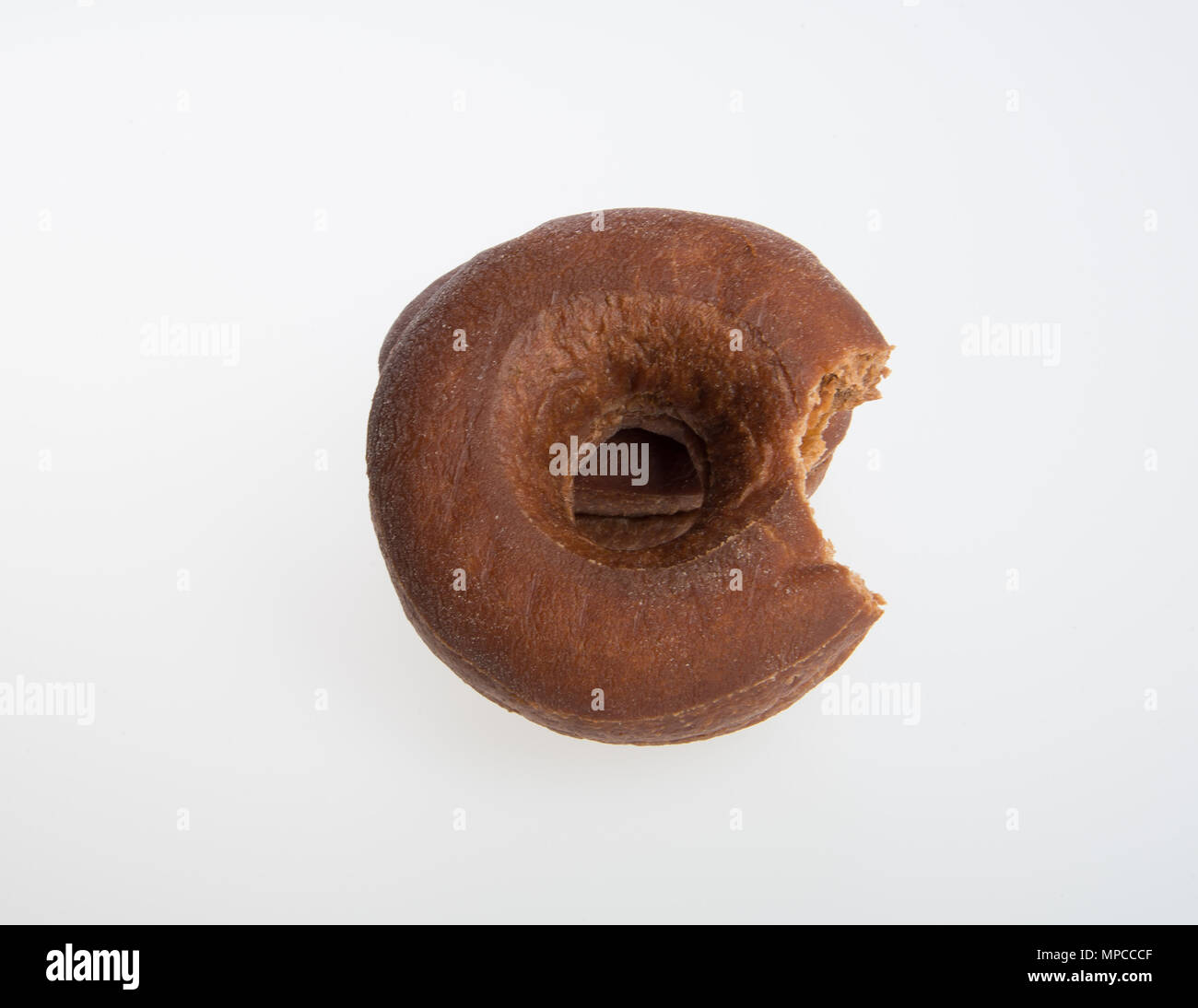 donut or donut with missing bite on a background Stock Photo - Alamy