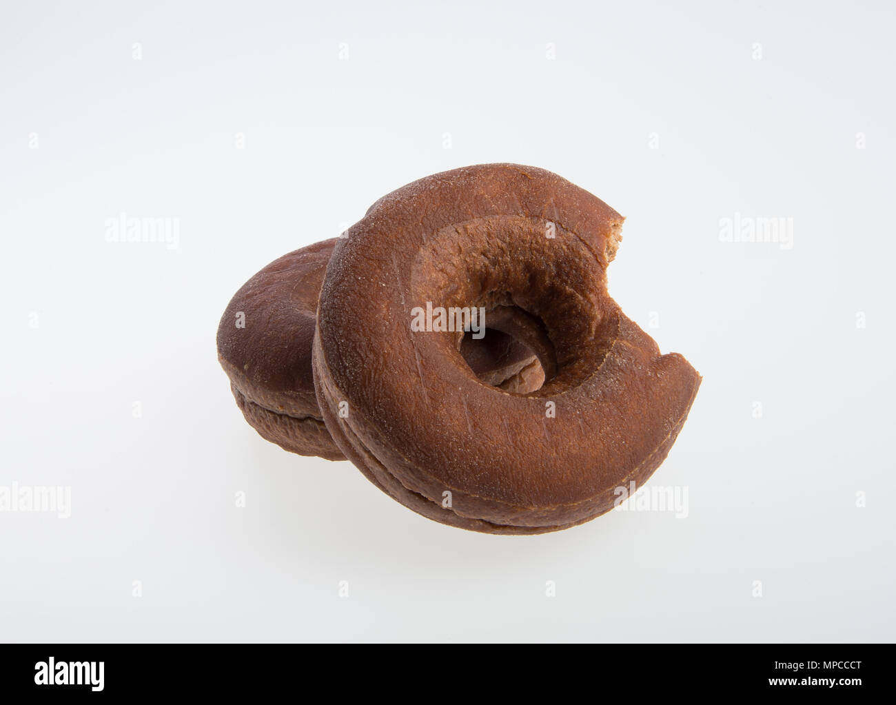donut or donut with missing bite on a background Stock Photo - Alamy