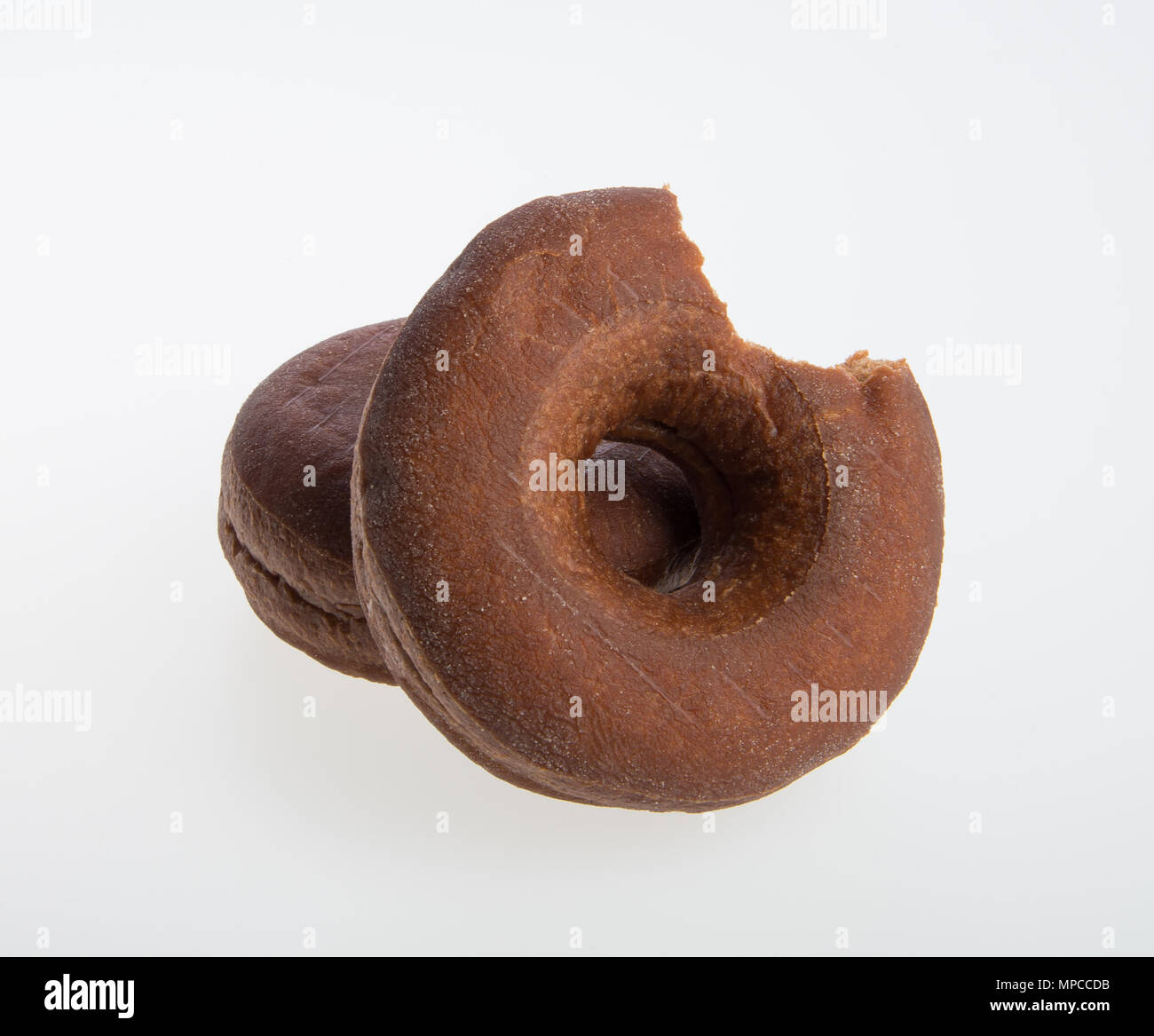 donut or donut with missing bite on a background Stock Photo - Alamy