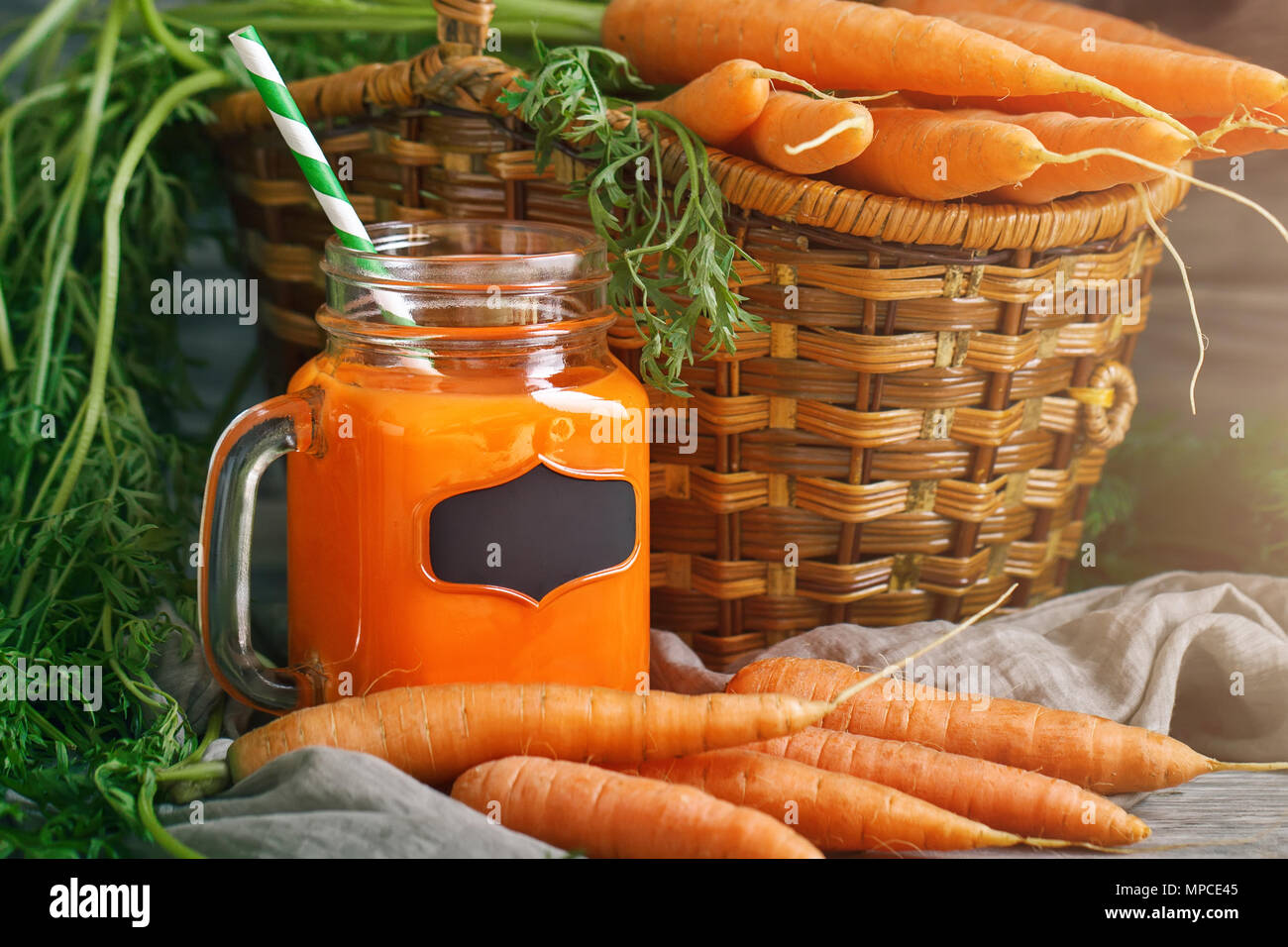 Fresh Carrot and carrot juice on Wooden Table in Garden. Vegetables ...