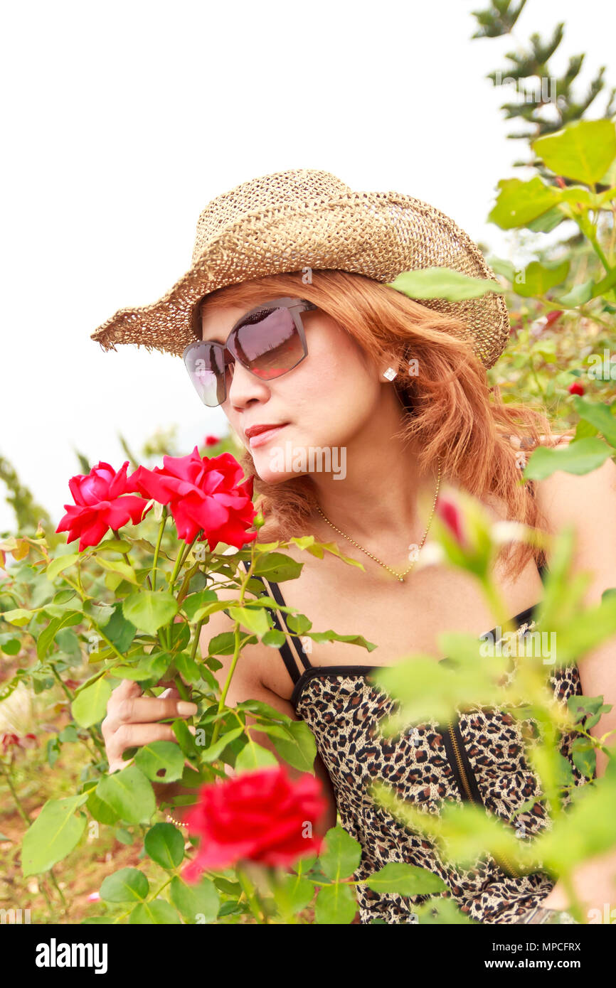 beautiful woman in garden with roses Stock Photo - Alamy