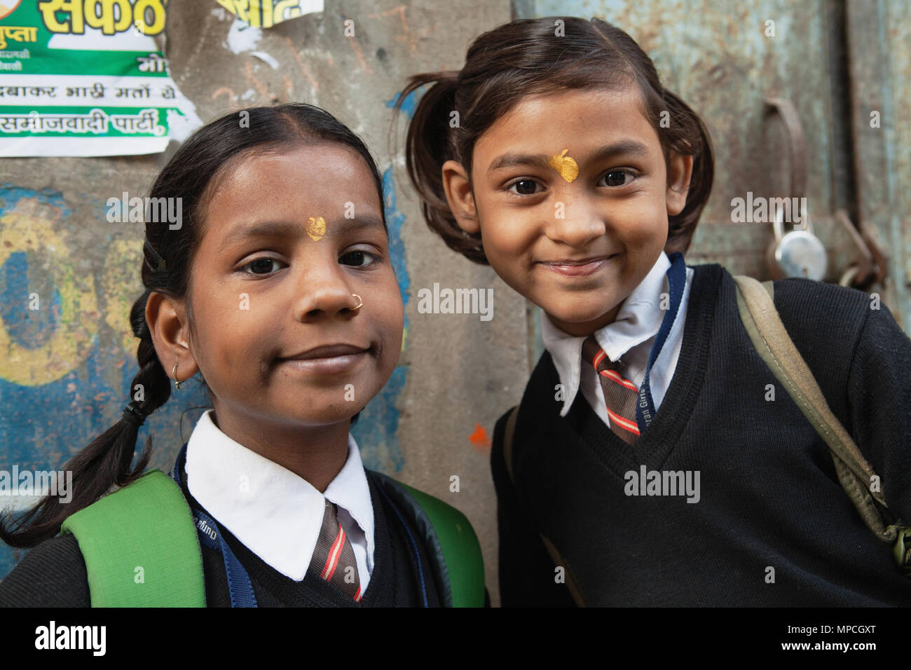 India, Uttar Pradesh, Varanasi, Portrait of two school girls with tika ...