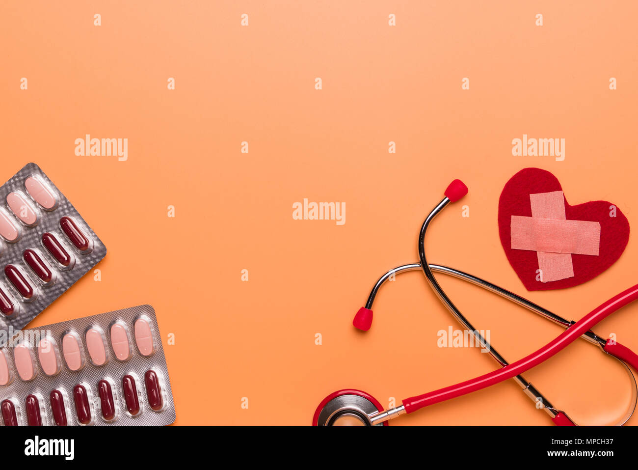 healthcare and medical concept red stethoscope and medicine on the ...