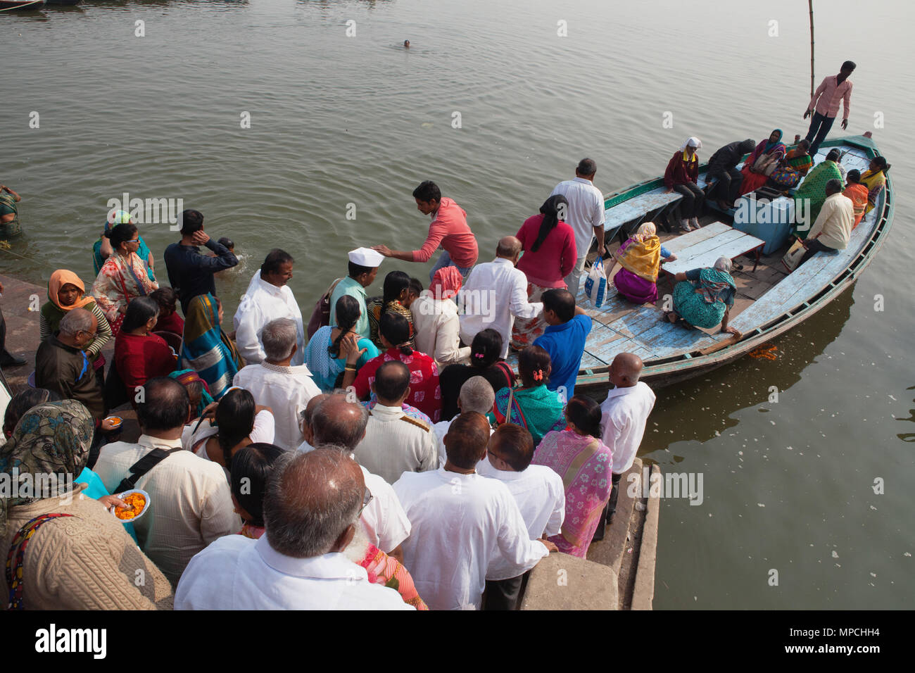 India, Uttar Pradesh, Varanasi, Pilgrims board a boat on the River ...