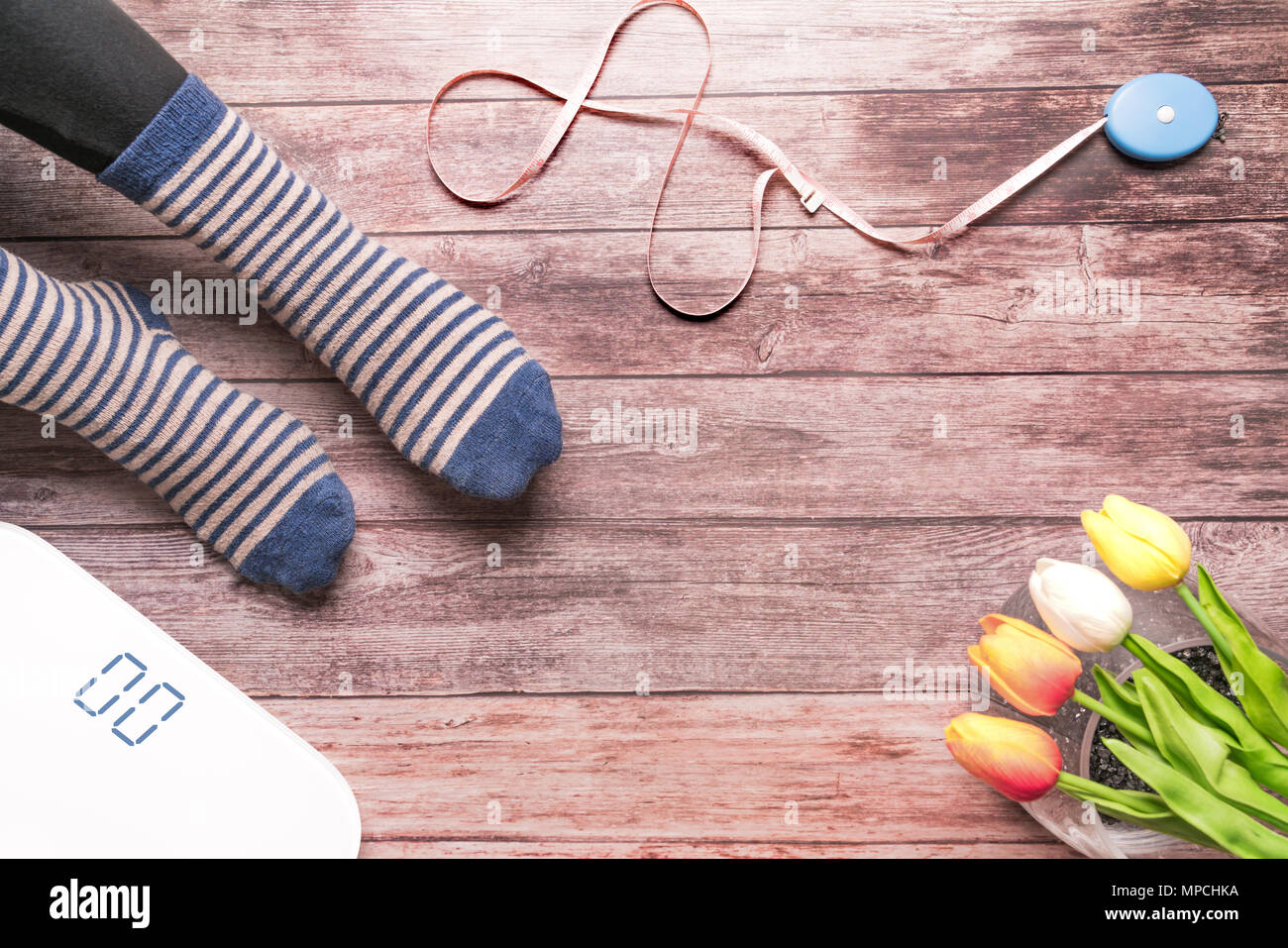 women wear strip sock sitting with white digital scale and measuring ...