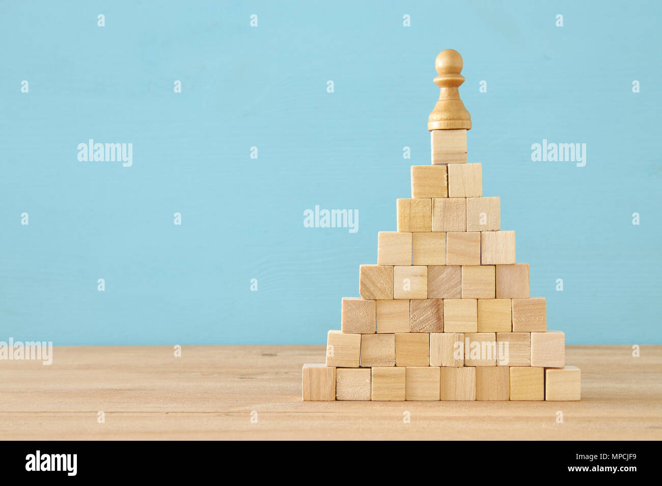 image of chess figure standing on a pyramid top. Business, competition ...