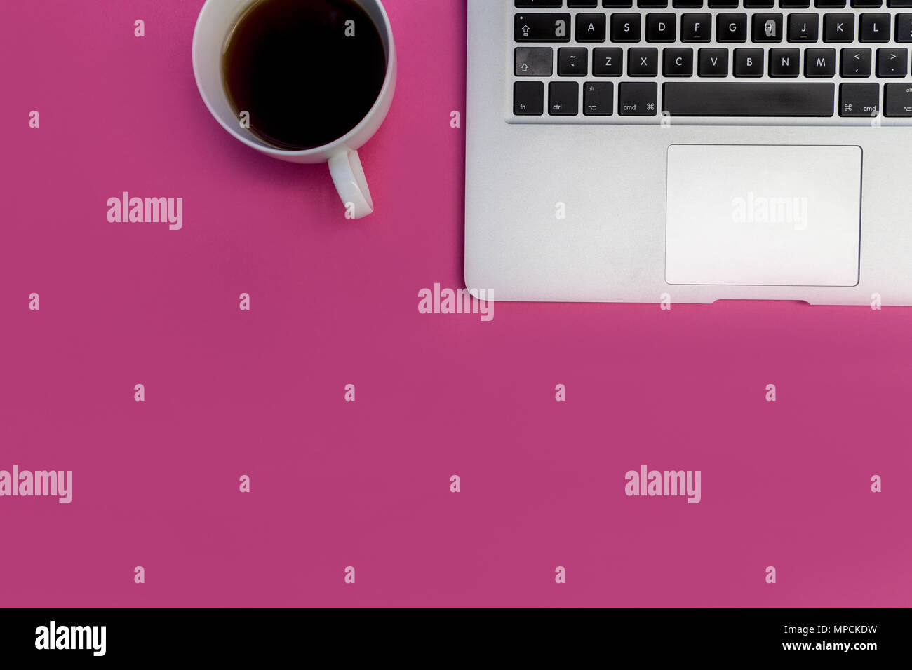 Laptop computer on bright pink background Stock Photo - Alamy