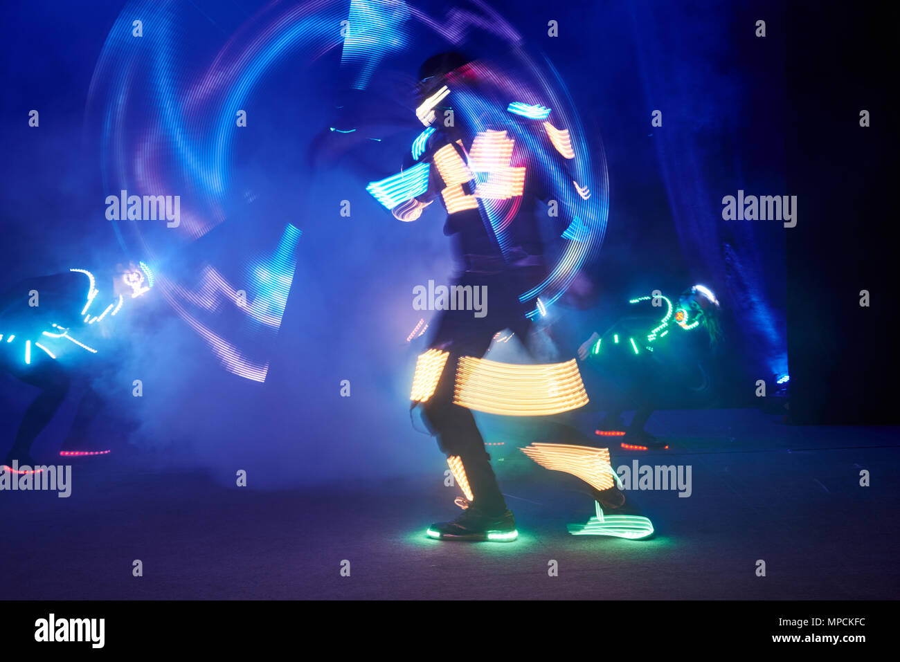 Laser show performance, dancers in led suits with LED lamp, very ...