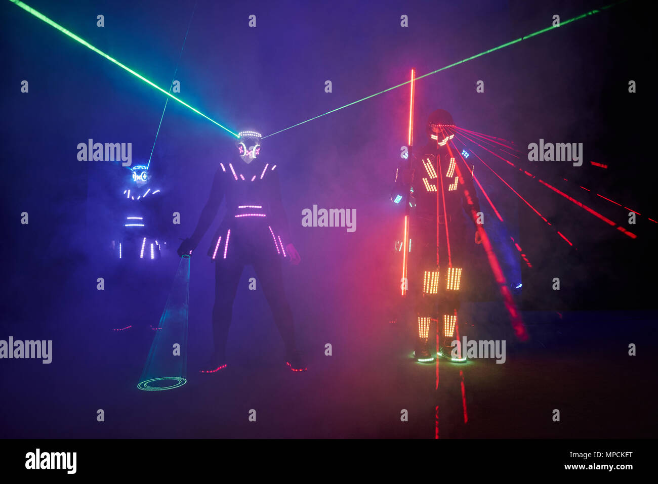 Laser show performance, dancers in led suits with LED lamp, very ...