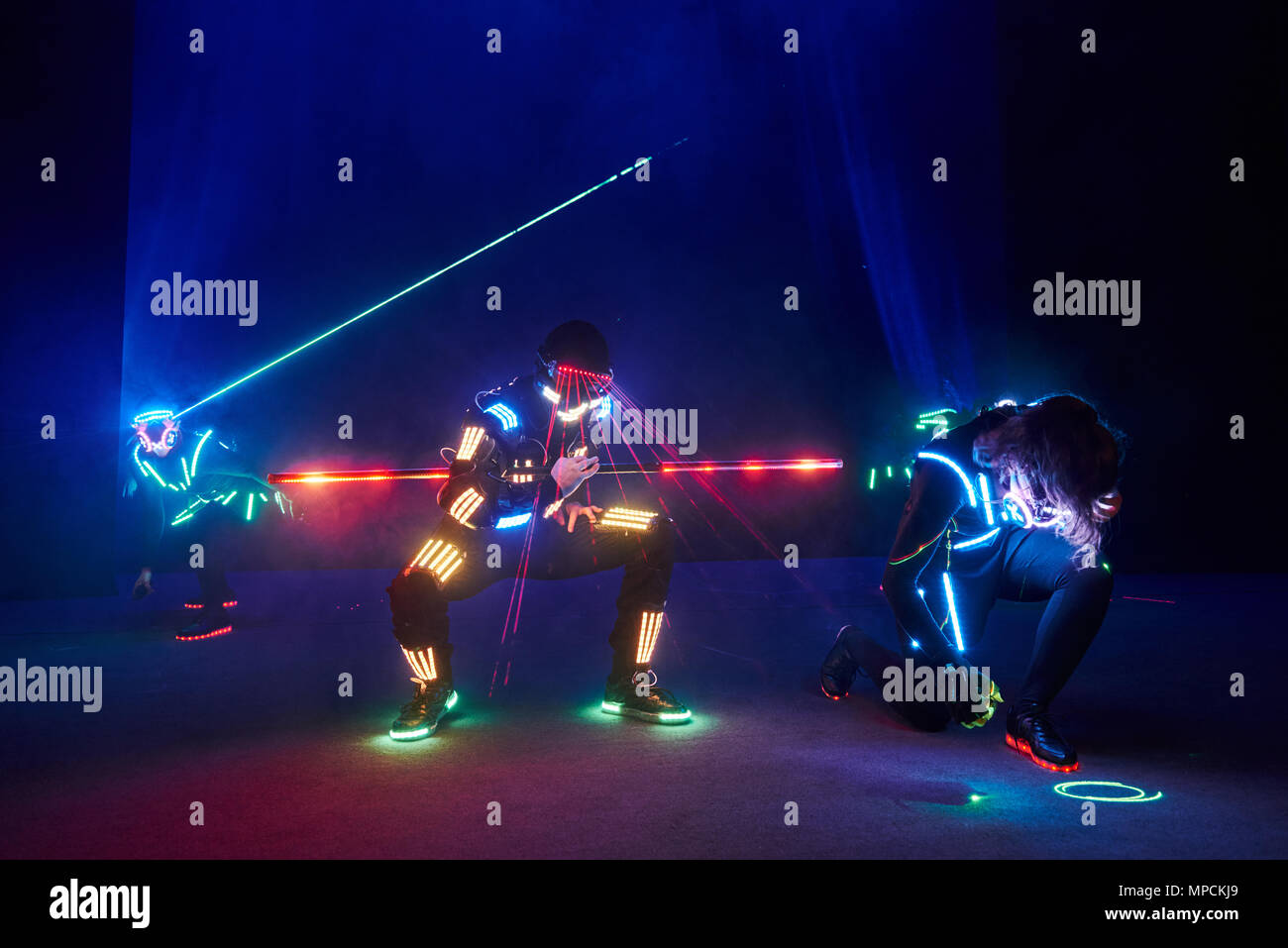 Laser show performance, dancers in led suits with LED lamp, very ...