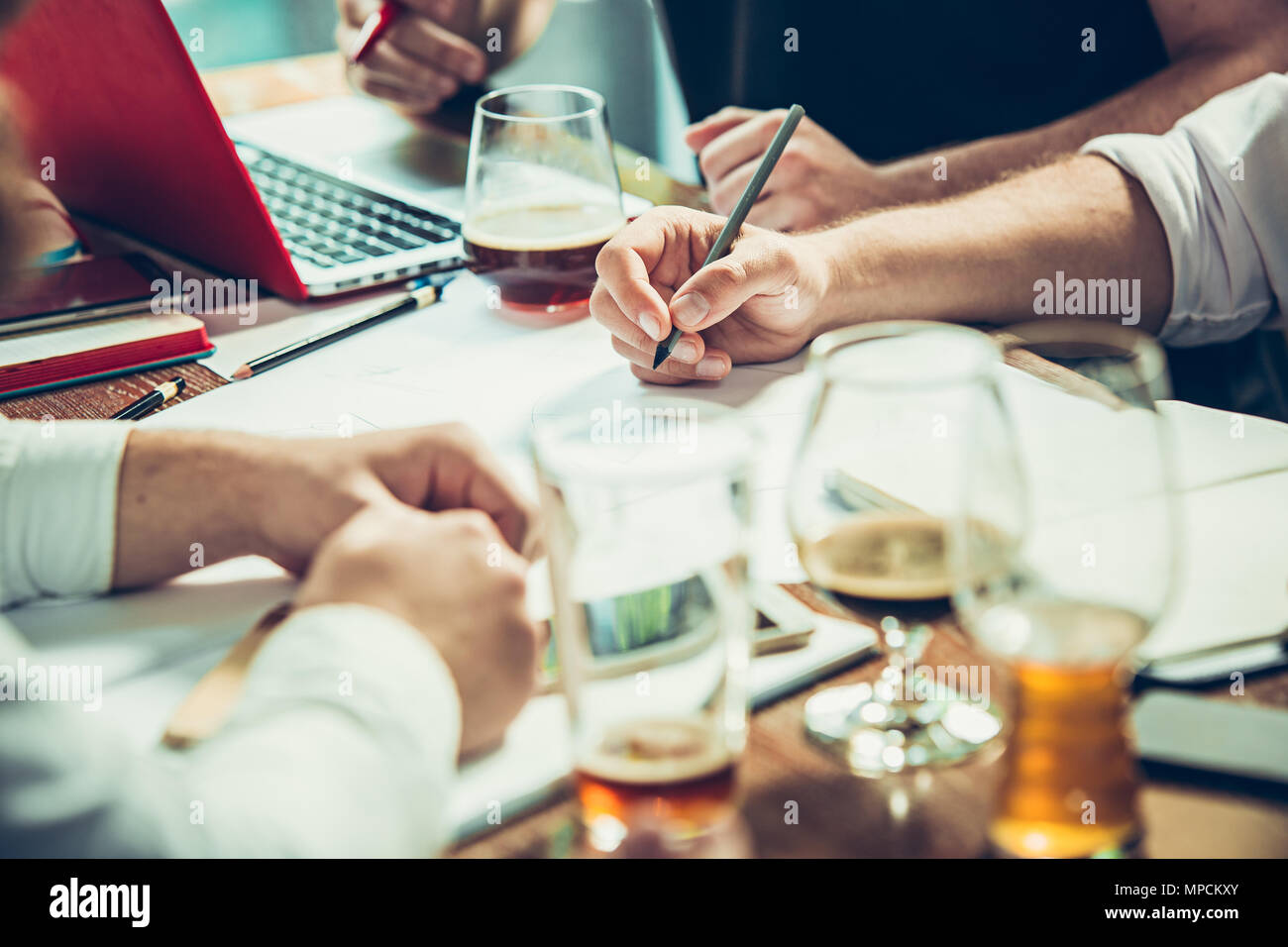 The hands of people working and relaxing in pub Stock Photo - Alamy