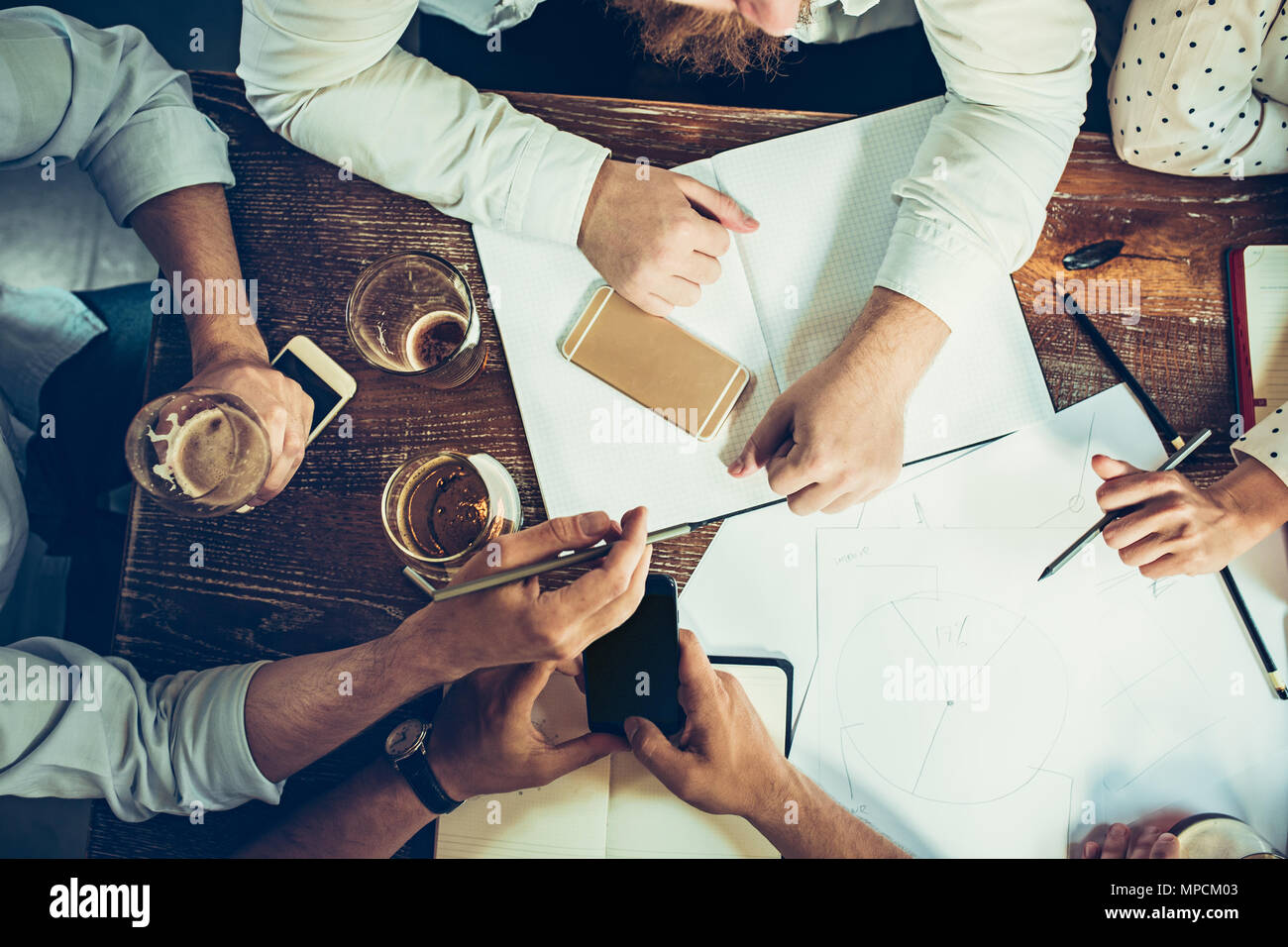 The hands of people working and relaxing in pub Stock Photo - Alamy
