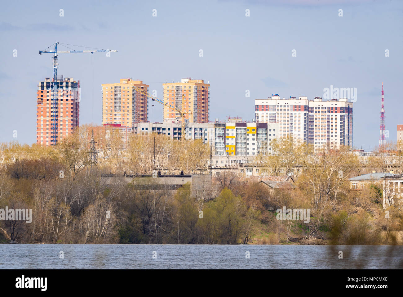 Cityscape. High-rise buildings on the river bank in a clear sunny day ...
