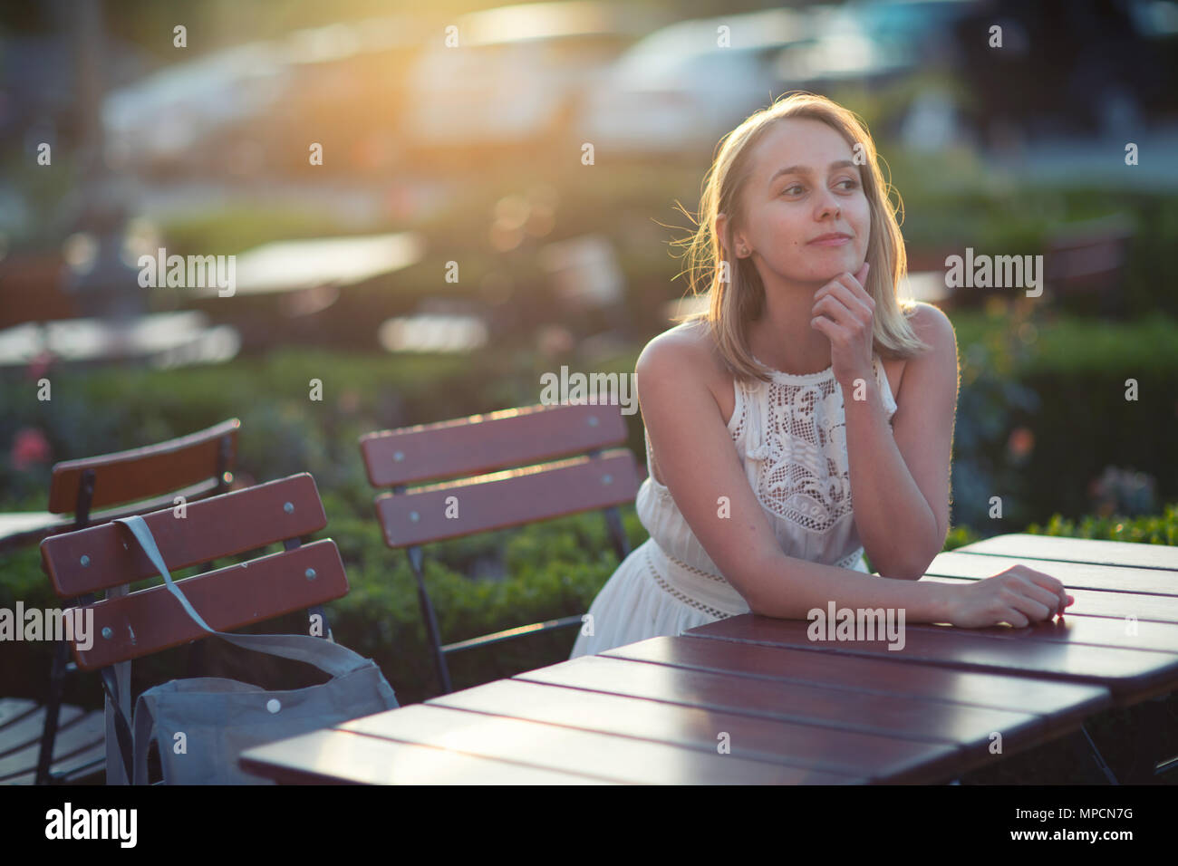 Beautiful woman sitting patio table hi-res stock photography and images ...