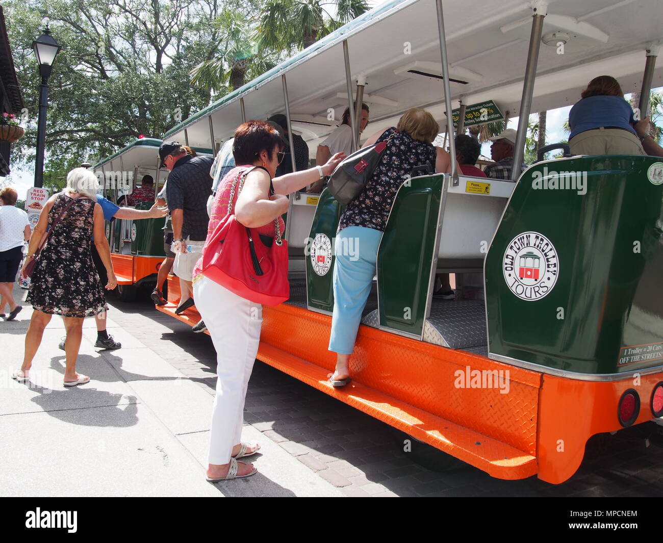 Tourists hopping on and off the Old Town Trolley in St. Augustine ...