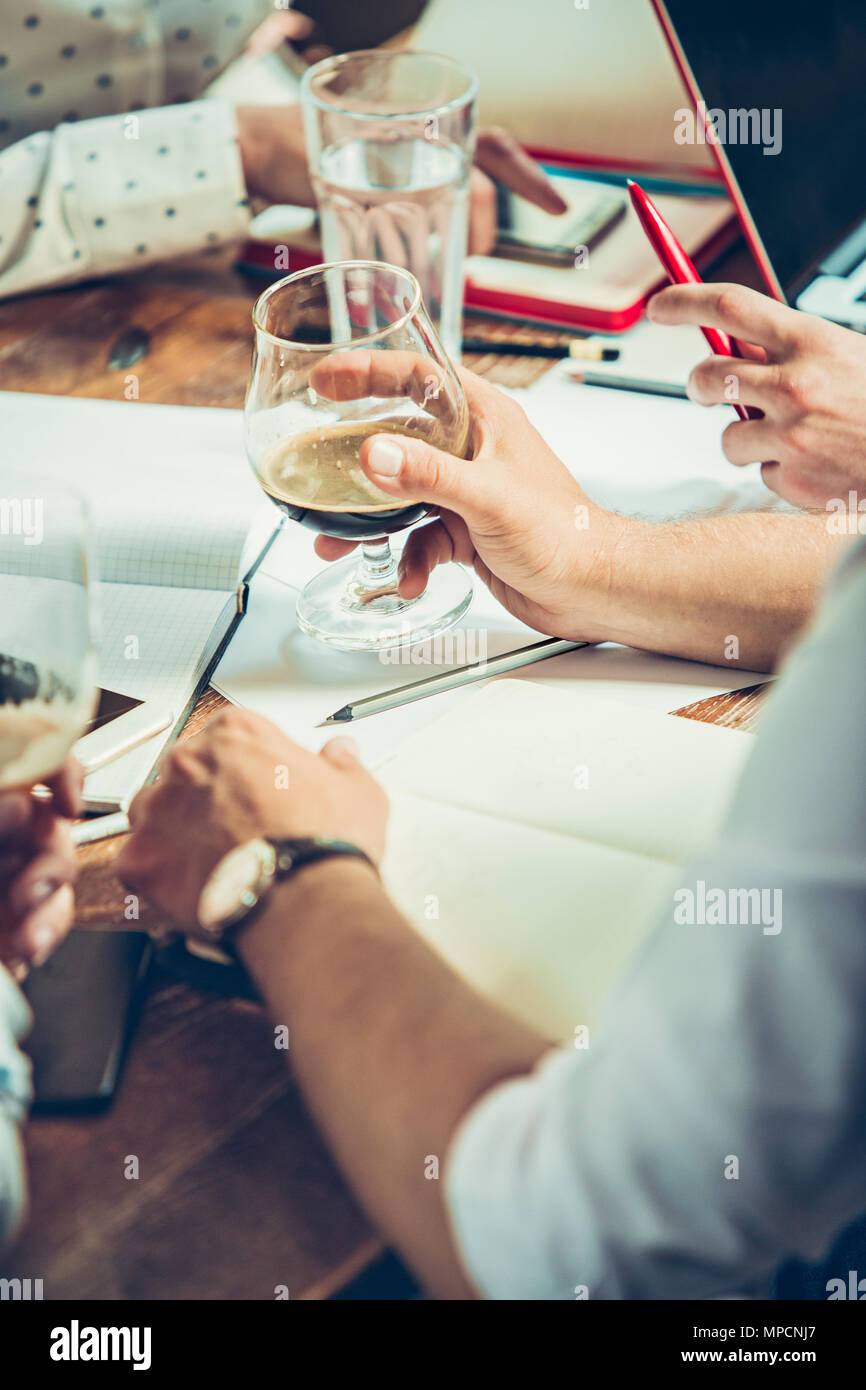 The hands of people working and relaxing in pub Stock Photo - Alamy